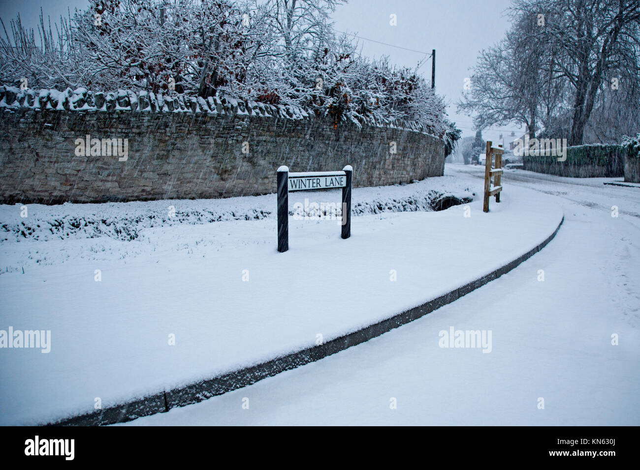 A street furniture sign on a snow covered countryside road junction ...