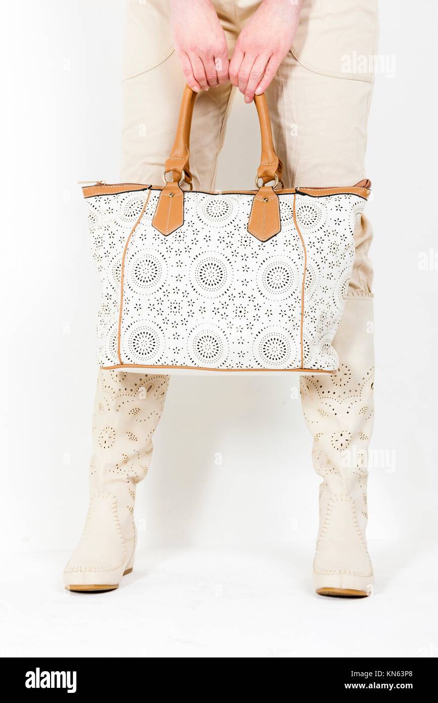 detail of standing woman wearing summer boots holding a handbag Stock ...