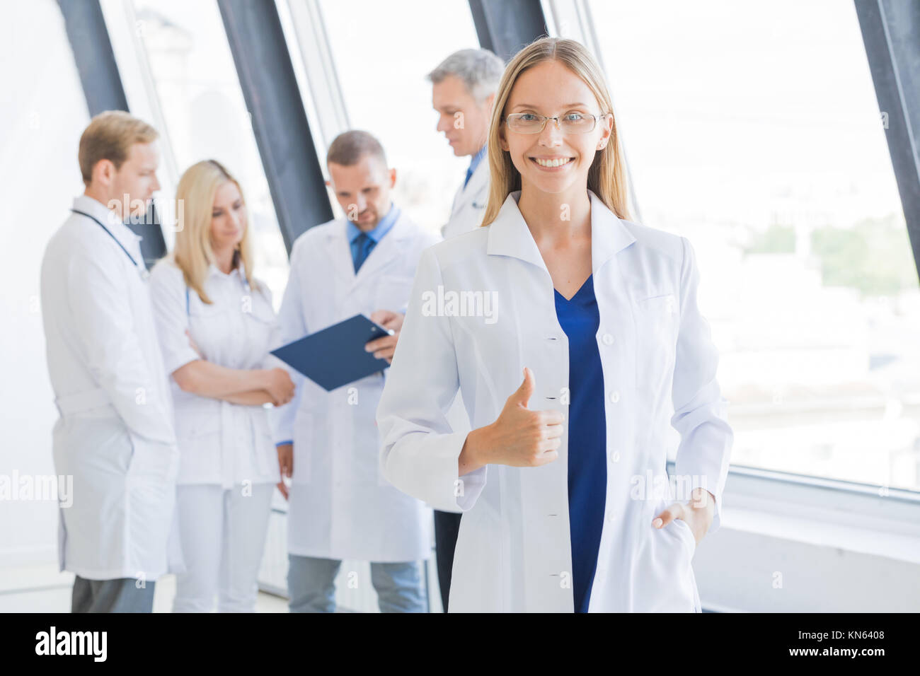 Young female doctor and medical team in hospital Stock Photo - Alamy
