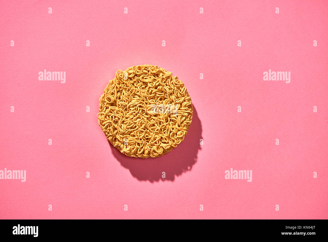Dried instant noodles isolated on a pink background Stock Photo - Alamy