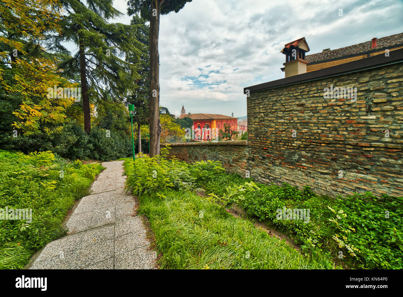 paved path in a green forest landscape setting near typical Italian ...