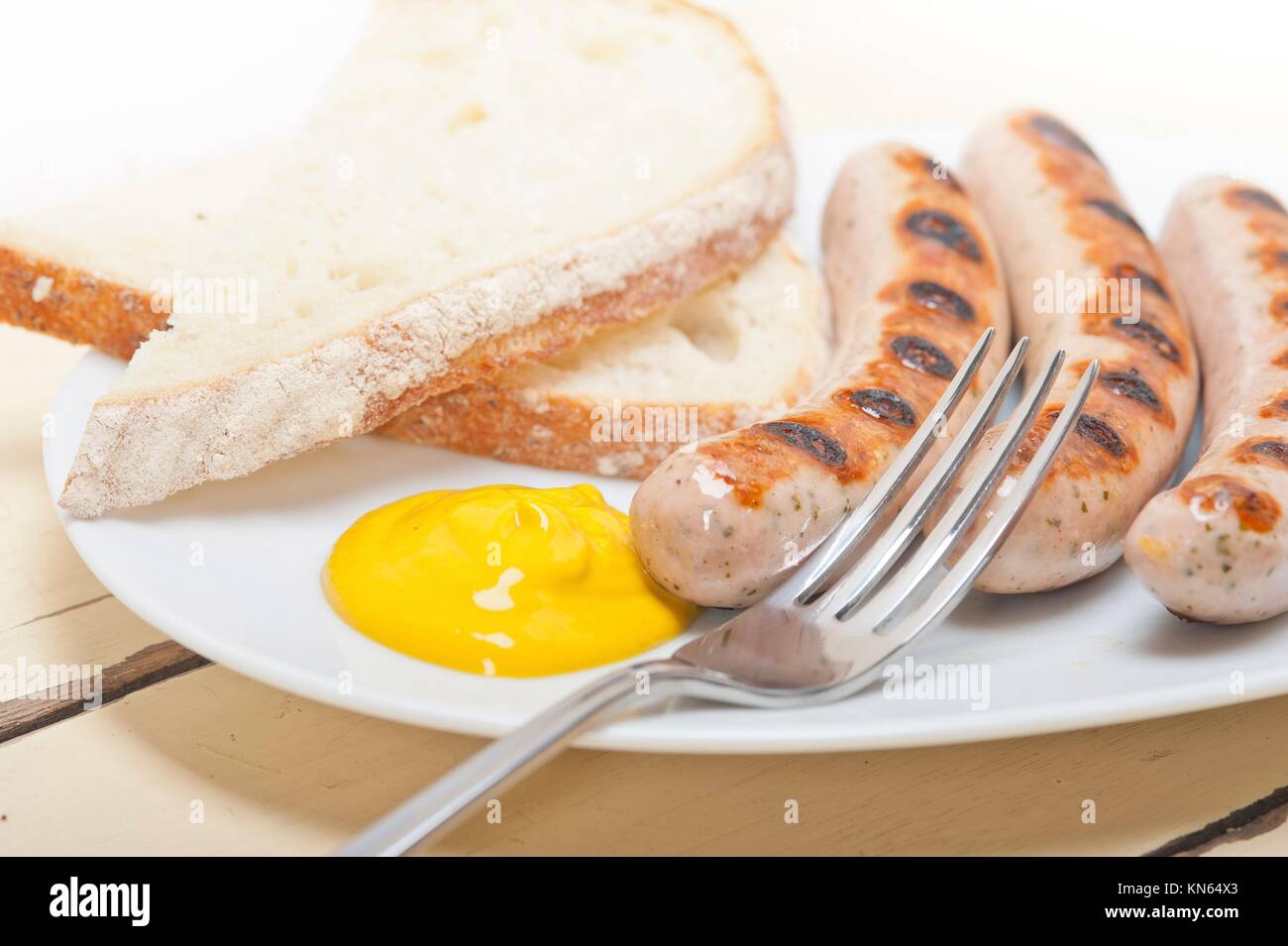 traditional fresh German wurstel sausages grilled with yellow mustard ...