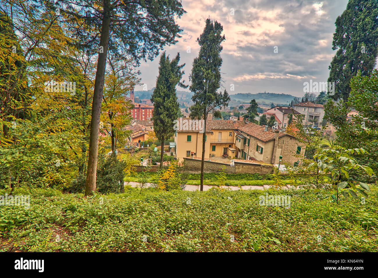 path in a green forest landscape setting near typical Italian village ...