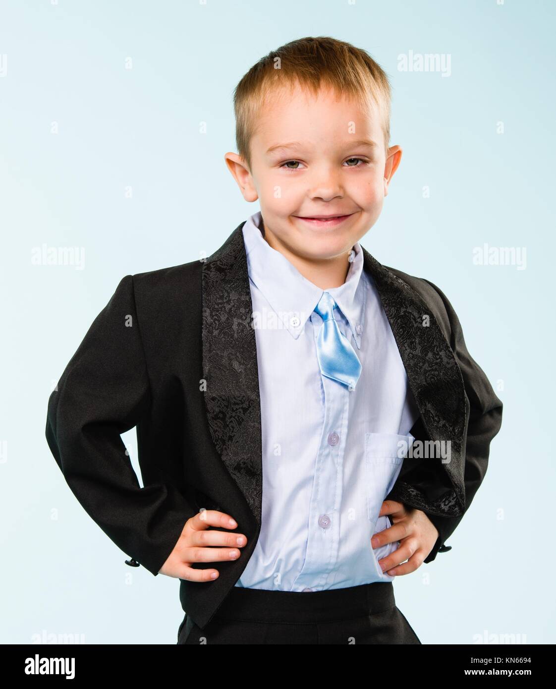 Handsome little boy posing on studio, light blue background Stock Photo ...