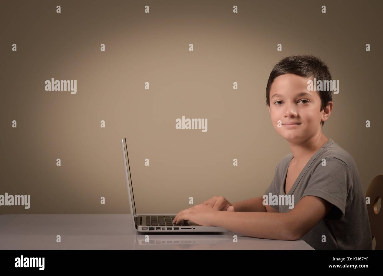 Little boy playing whith a computer Stock Photo - Alamy