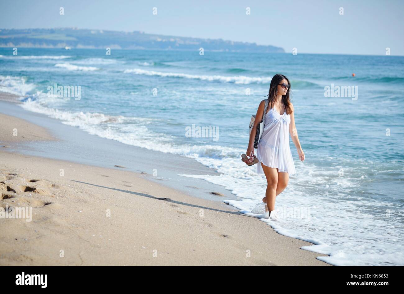 Woman walking on a beach hi-res stock photography and images - Alamy