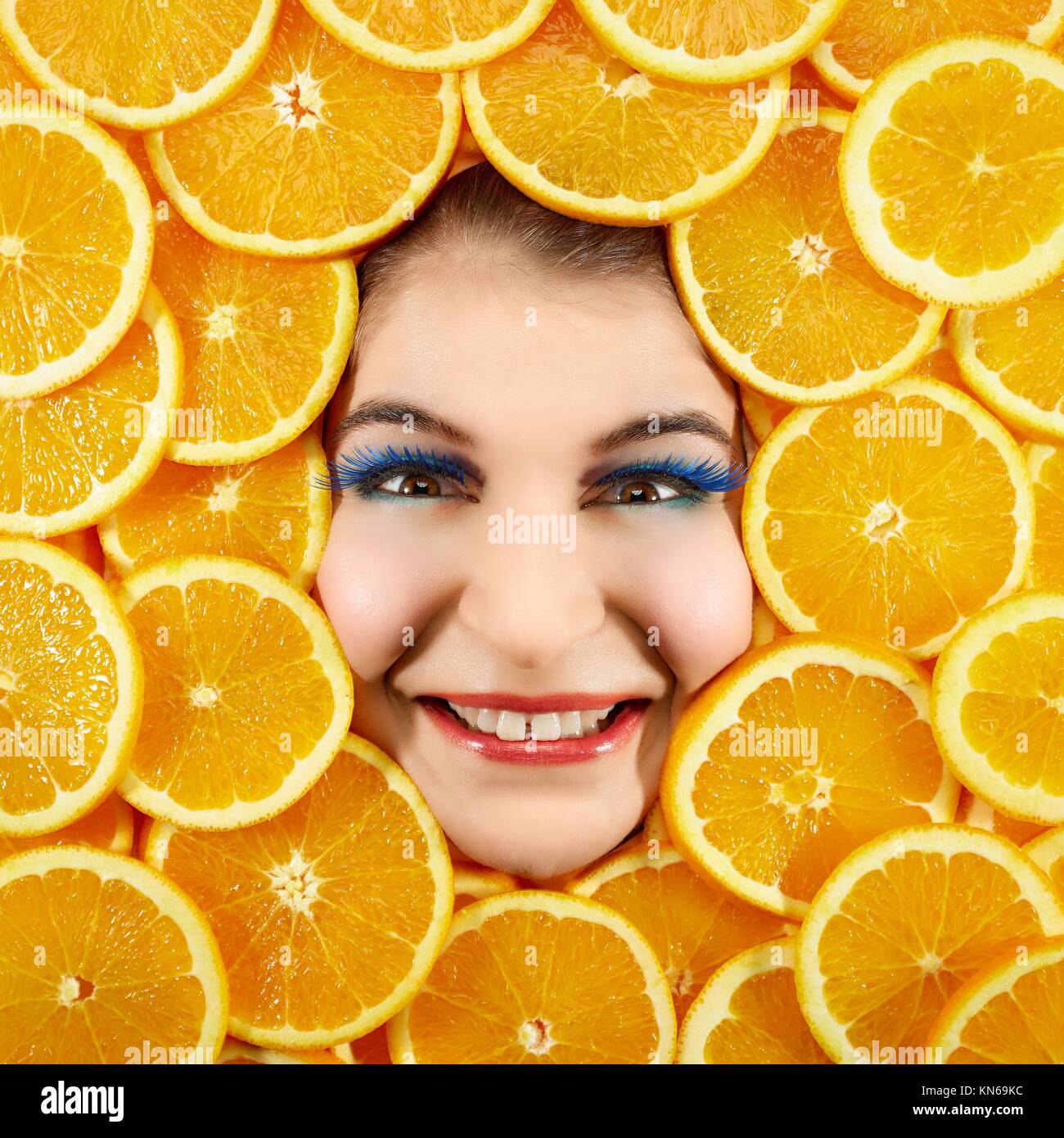 Beautiful woman expression face with orange slice frame Stock Photo - Alamy
