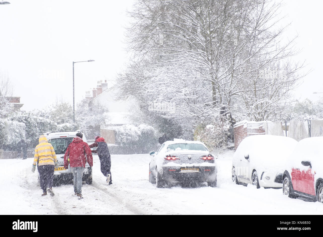 People Help Pushing Stuck Car in Heavy Snow Stock Photo - Alamy