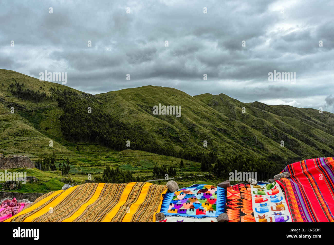Colorful Peruvian carpets decorating a green Andes mountains vista ...