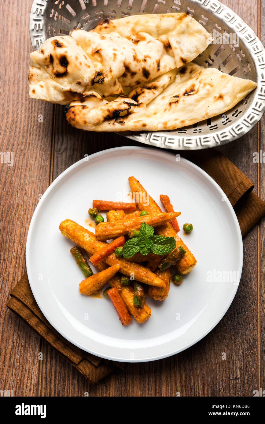 Indian Baby Corn Masala or spicy Baby corn curry served with roti or ...