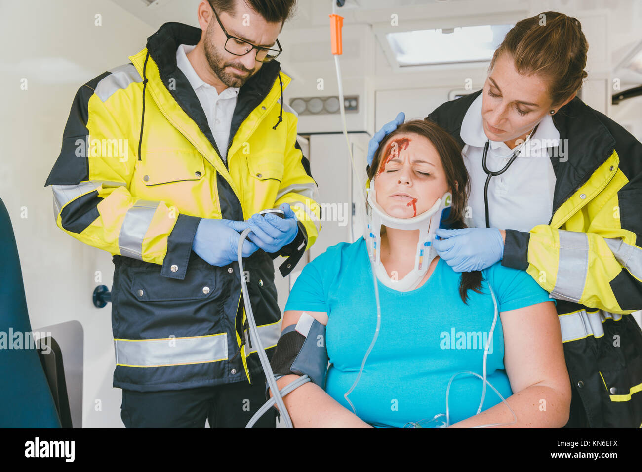 Medics taking care of inured woman in ambulance Stock Photo - Alamy