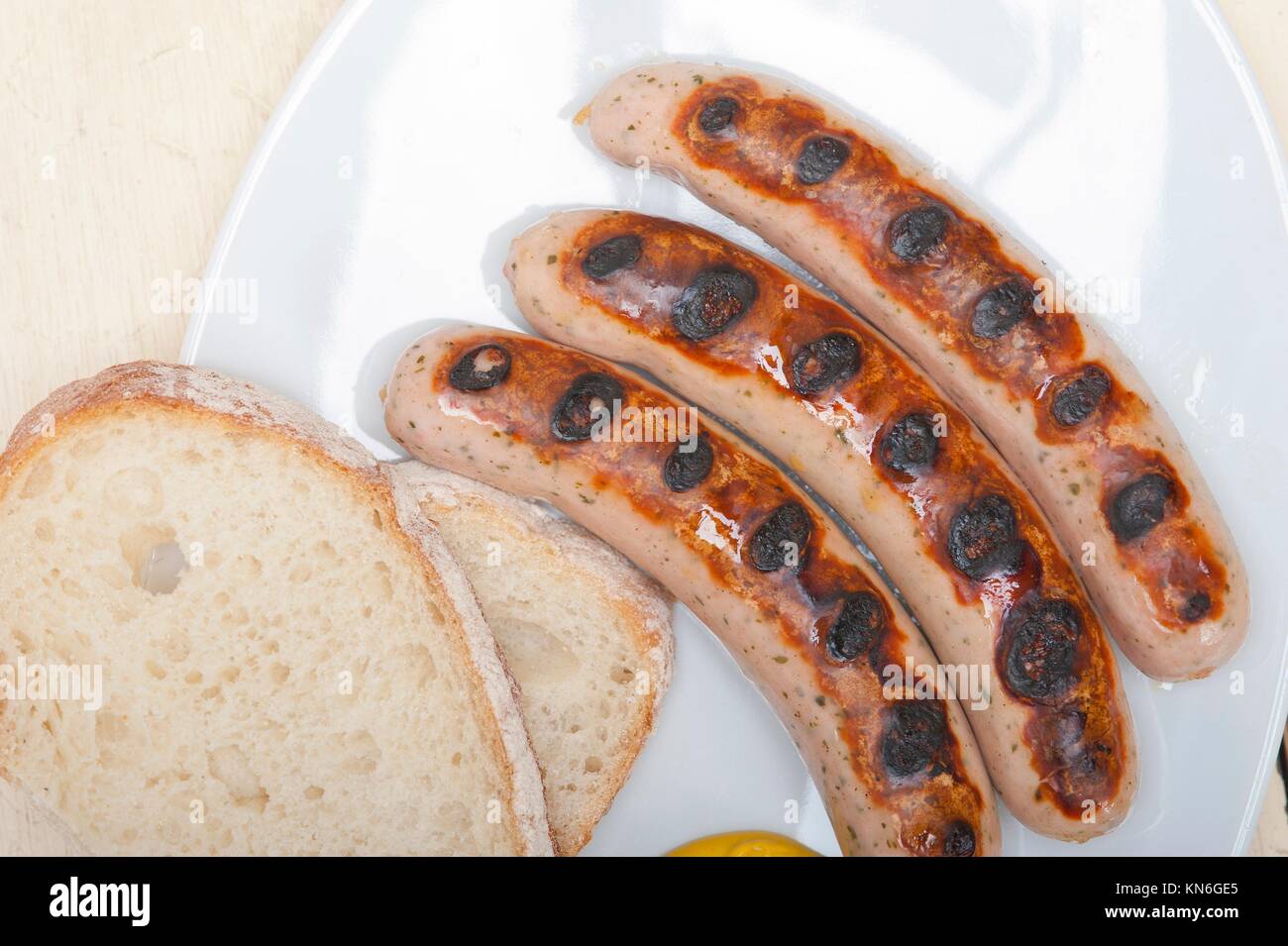 traditional fresh German wurstel sausages grilled with yellow mustard ...