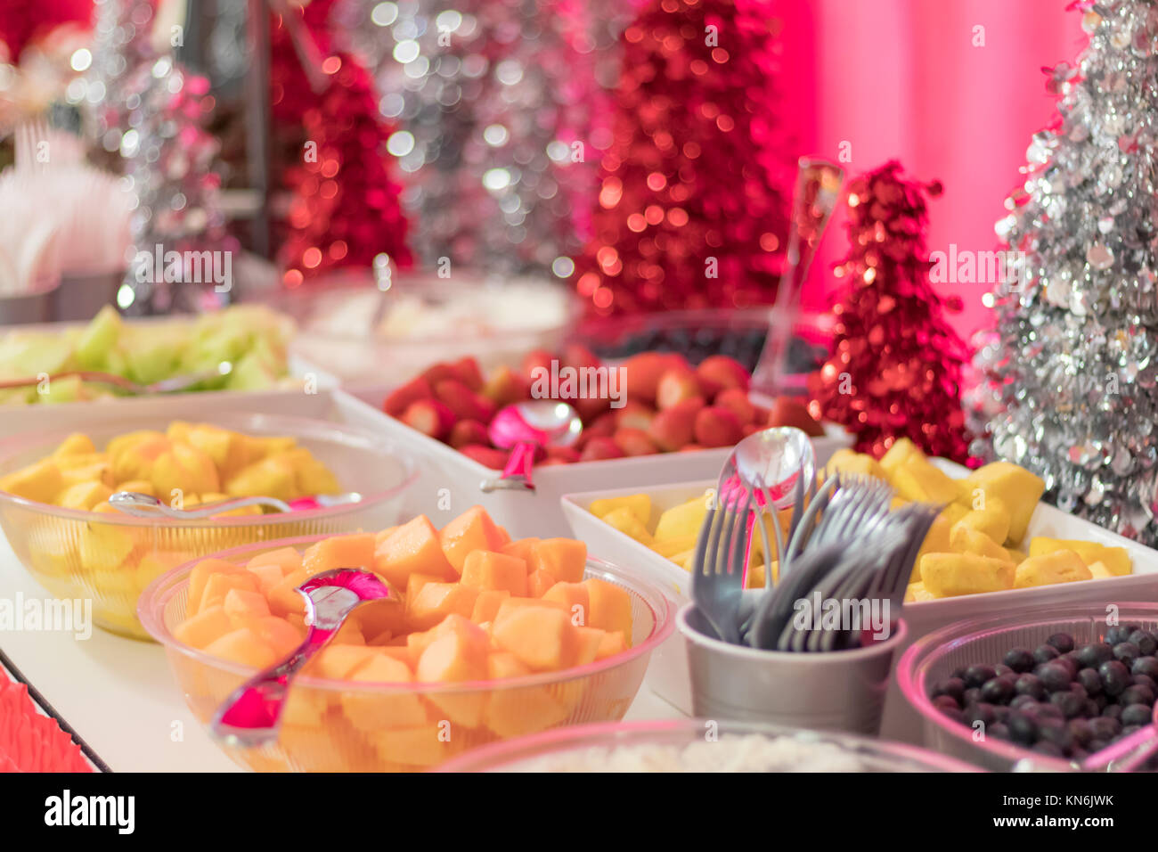 Holiday Party dessert table with assorted fresh fruit including melon ...