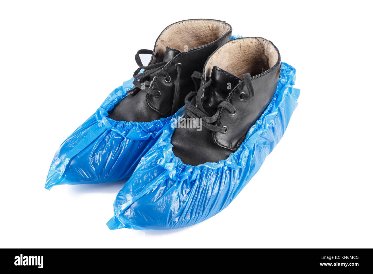 blue protective shoe covers on men's shoes isolated on white background ...