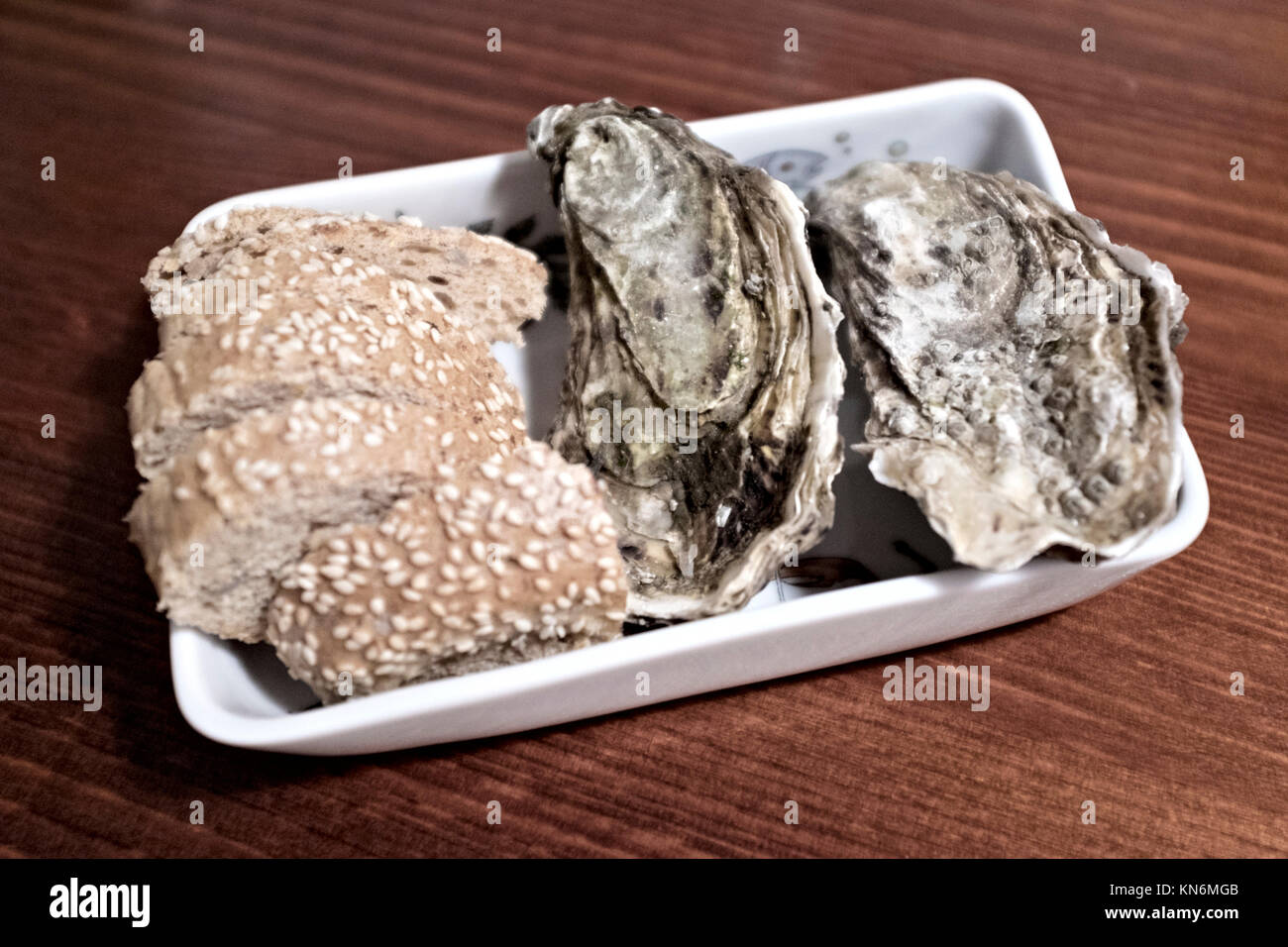 Oysters and bread on a plate Stock Photo - Alamy
