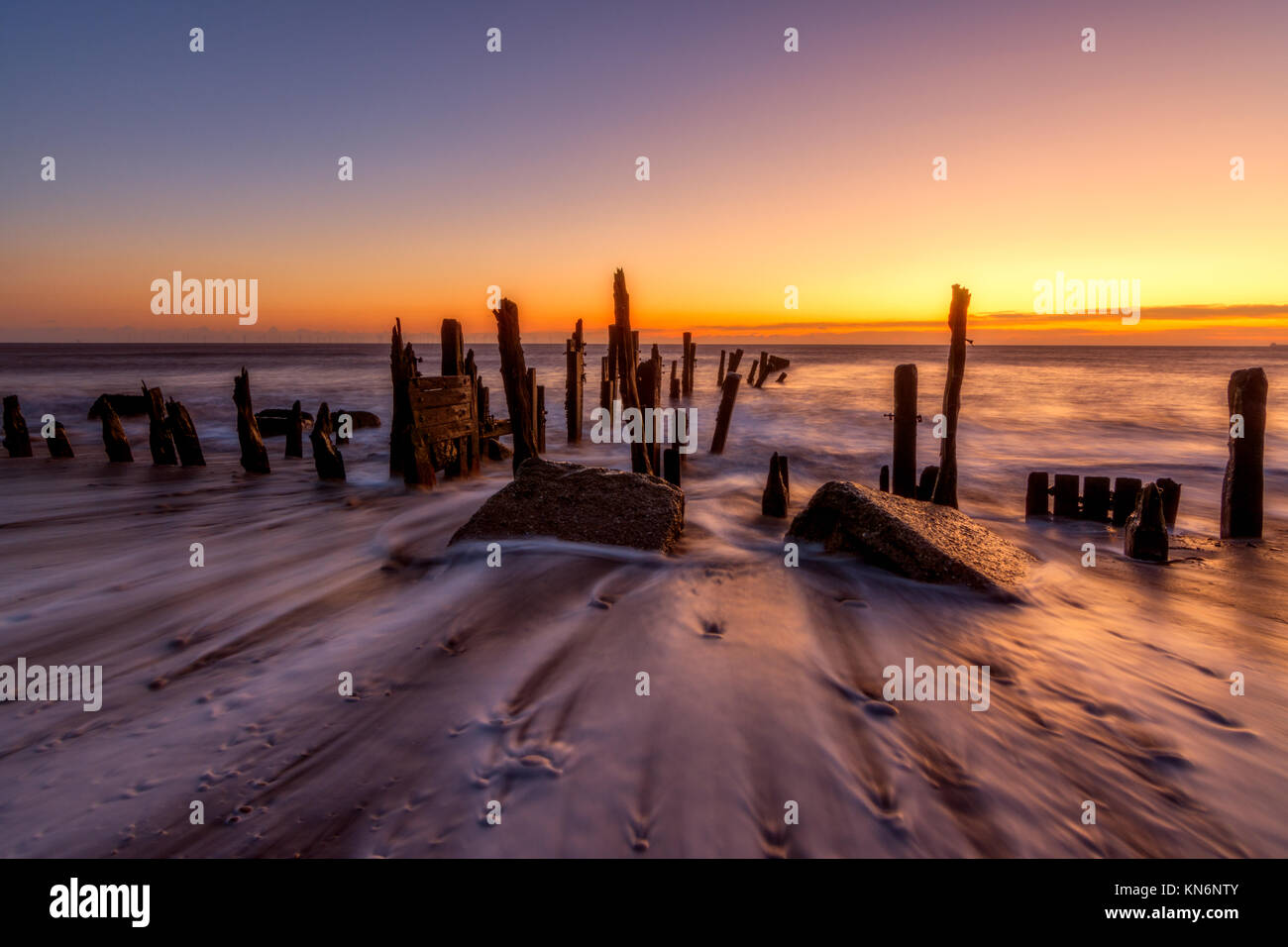 Waves wash down the beach and old coastal defenses at Spurn Point in ...