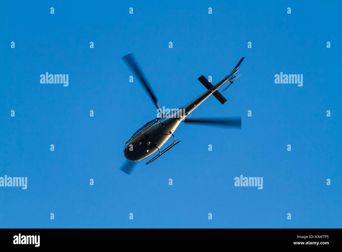 Helicopter under blue sky Stock Photo - Alamy