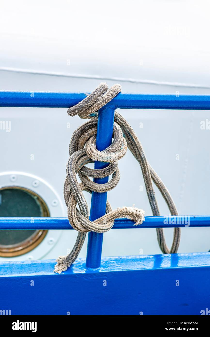 rope on a blue reling of a trawler Stock Photo - Alamy