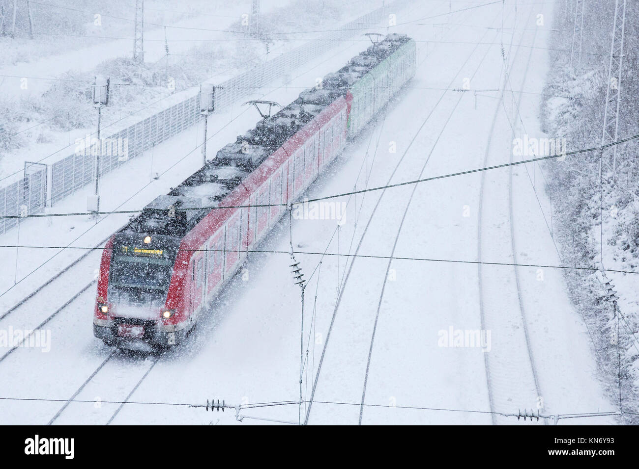 German S-Bahn suburban train in snowy weather, Mülheim an der Ruhr ...