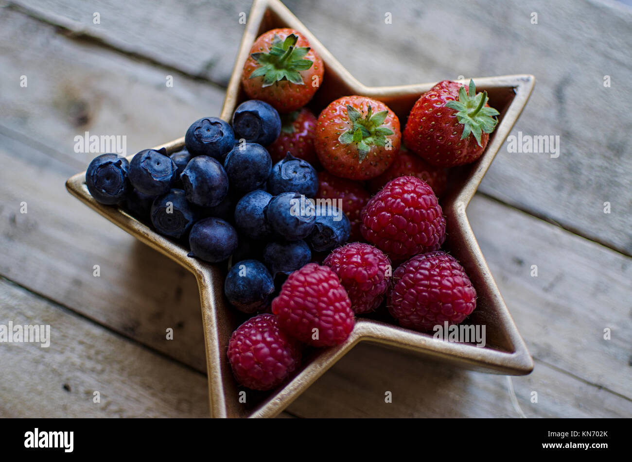 Superfood Berries in a Star Dish on Wood Stock Photo - Alamy