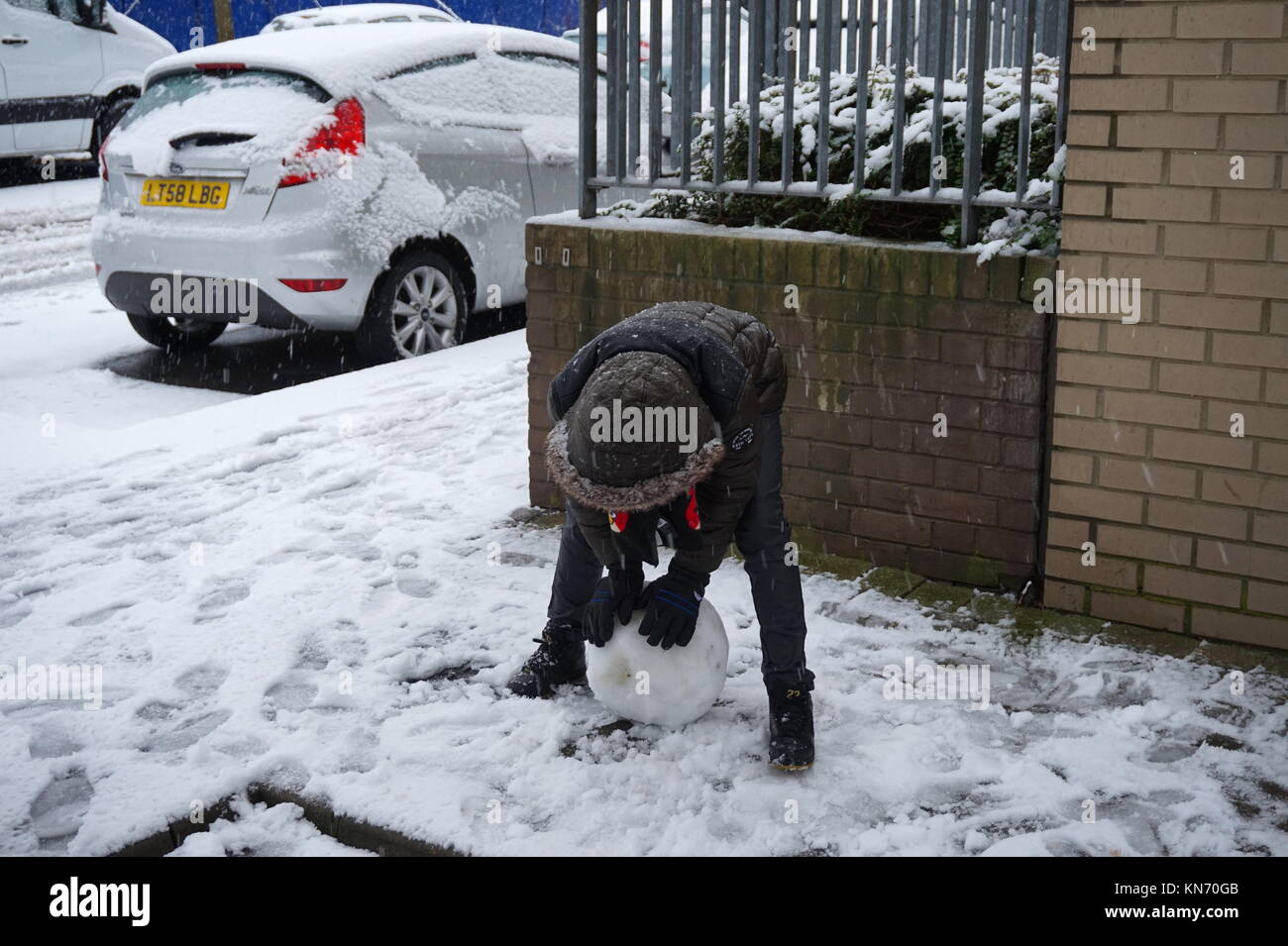 A young Afro-Caribbean boy playing in the snow in the United Kingdom ...