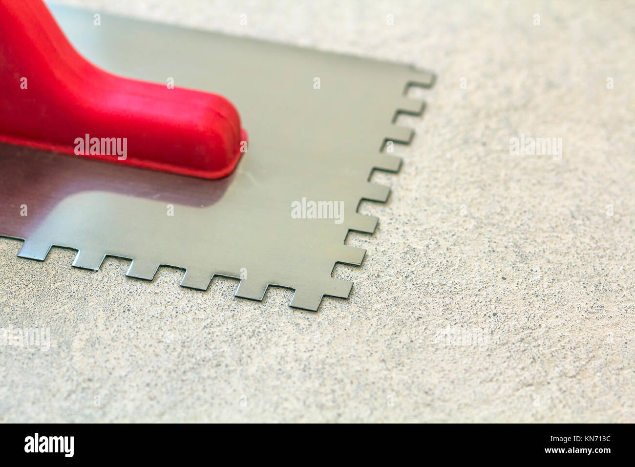 Construction notched trowel is a tool for tiles installation work Stock ...