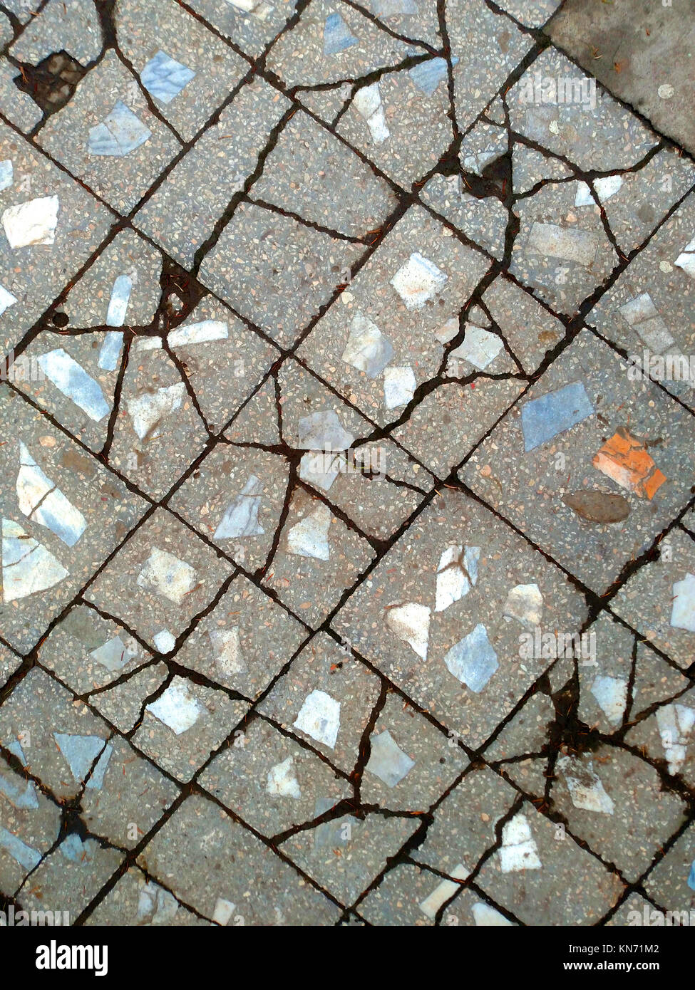 Pavement made from old cracked concrete tiles Stock Photo - Alamy