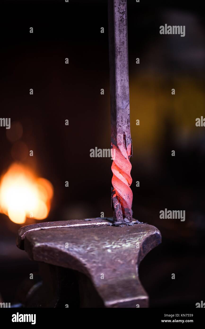 Ironworker forging hot iron in workshop Stock Photo - Alamy