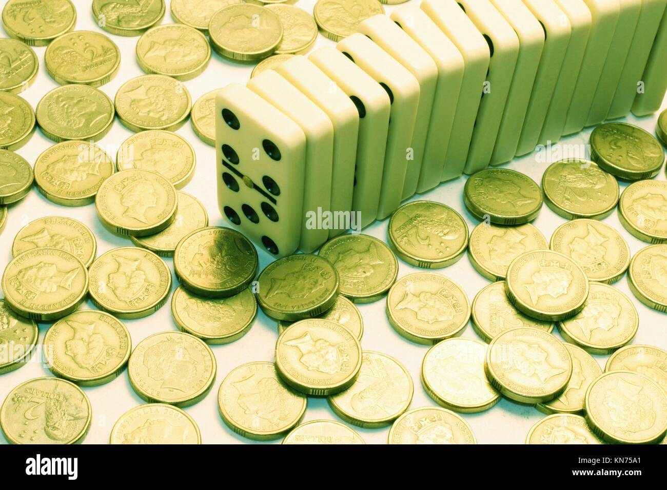Dominoes on coins Stock Photo - Alamy