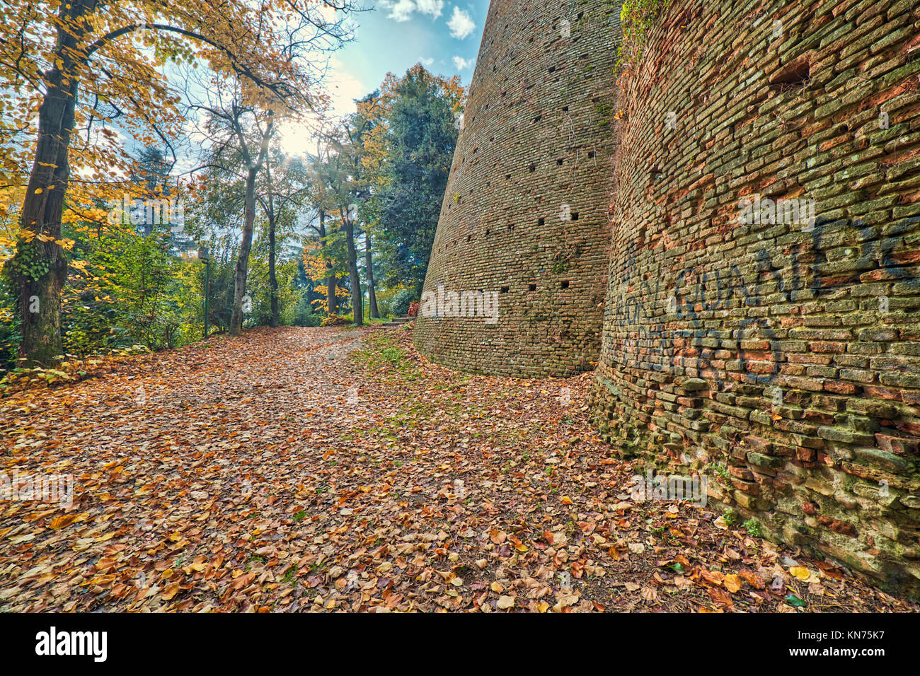 path near ancient walls of medieval castle in a green forest landscape ...