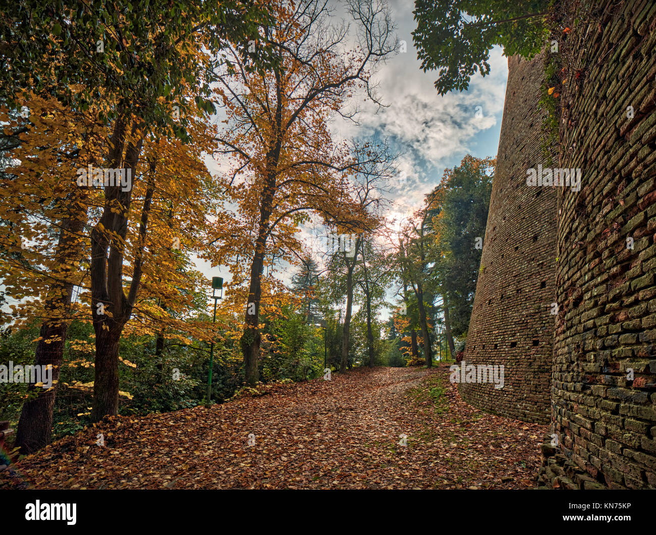 path near ancient walls of medieval castle in a green forest landscape ...