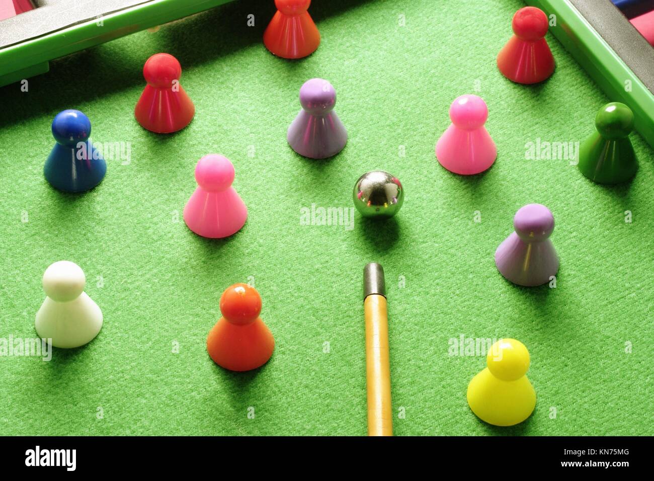 Game pieces on toy snooker Stock Photo - Alamy
