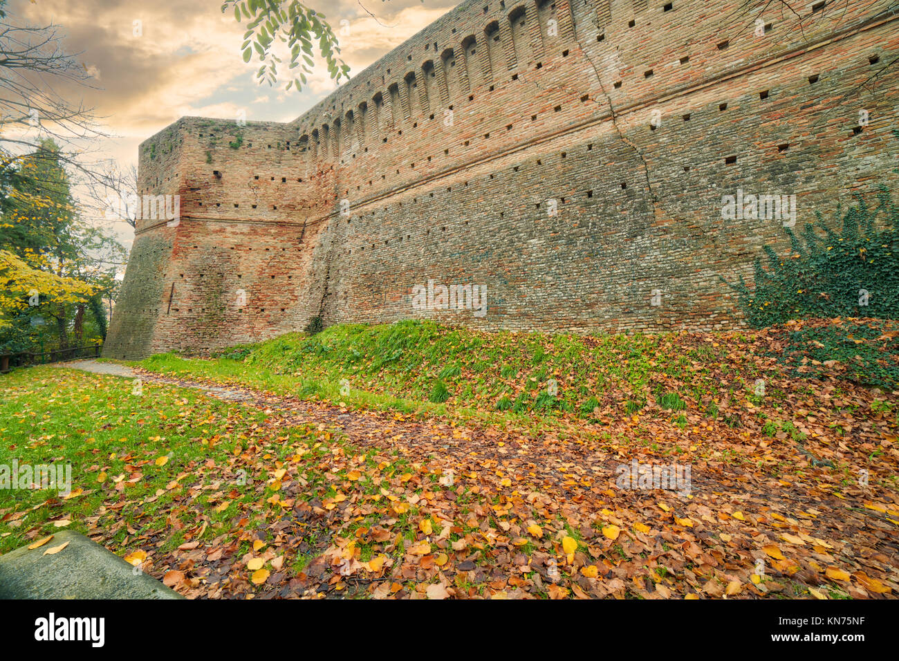 path near ancient walls of medieval castle in a green forest landscape ...