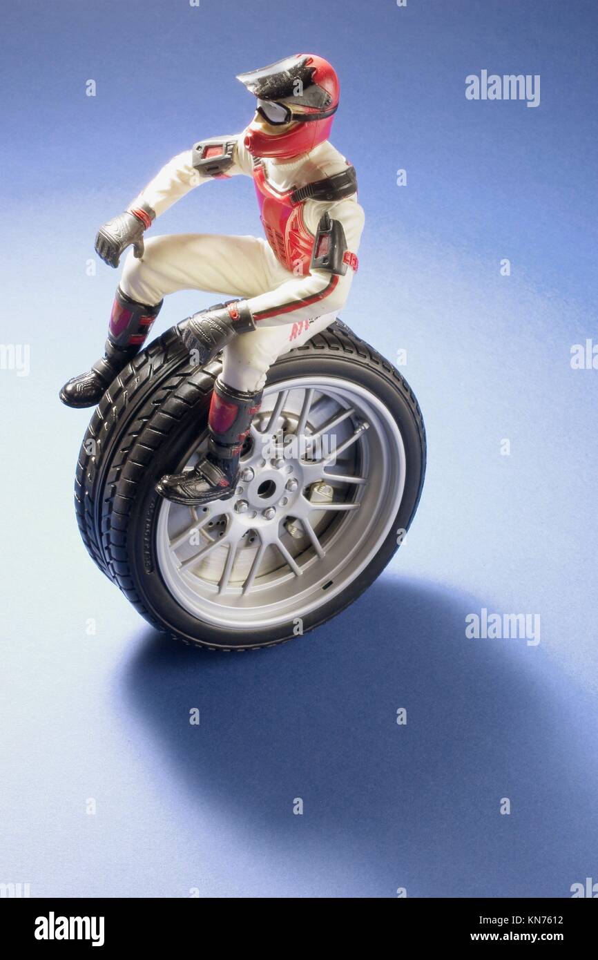 Racing driver figure on miniature wheel Stock Photo - Alamy