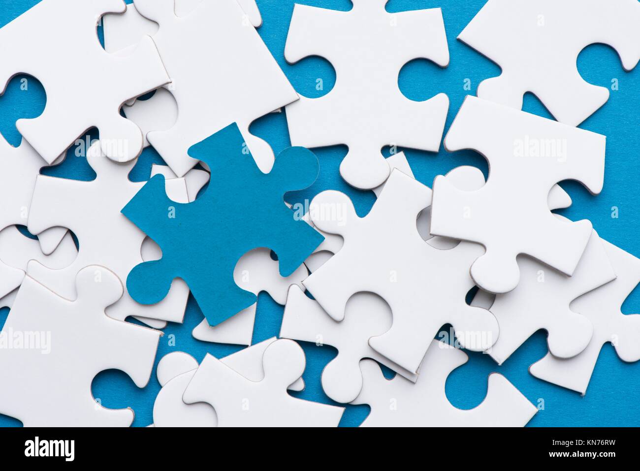 Blue puzzle piece on white pieces. Conceptual image of connection ...