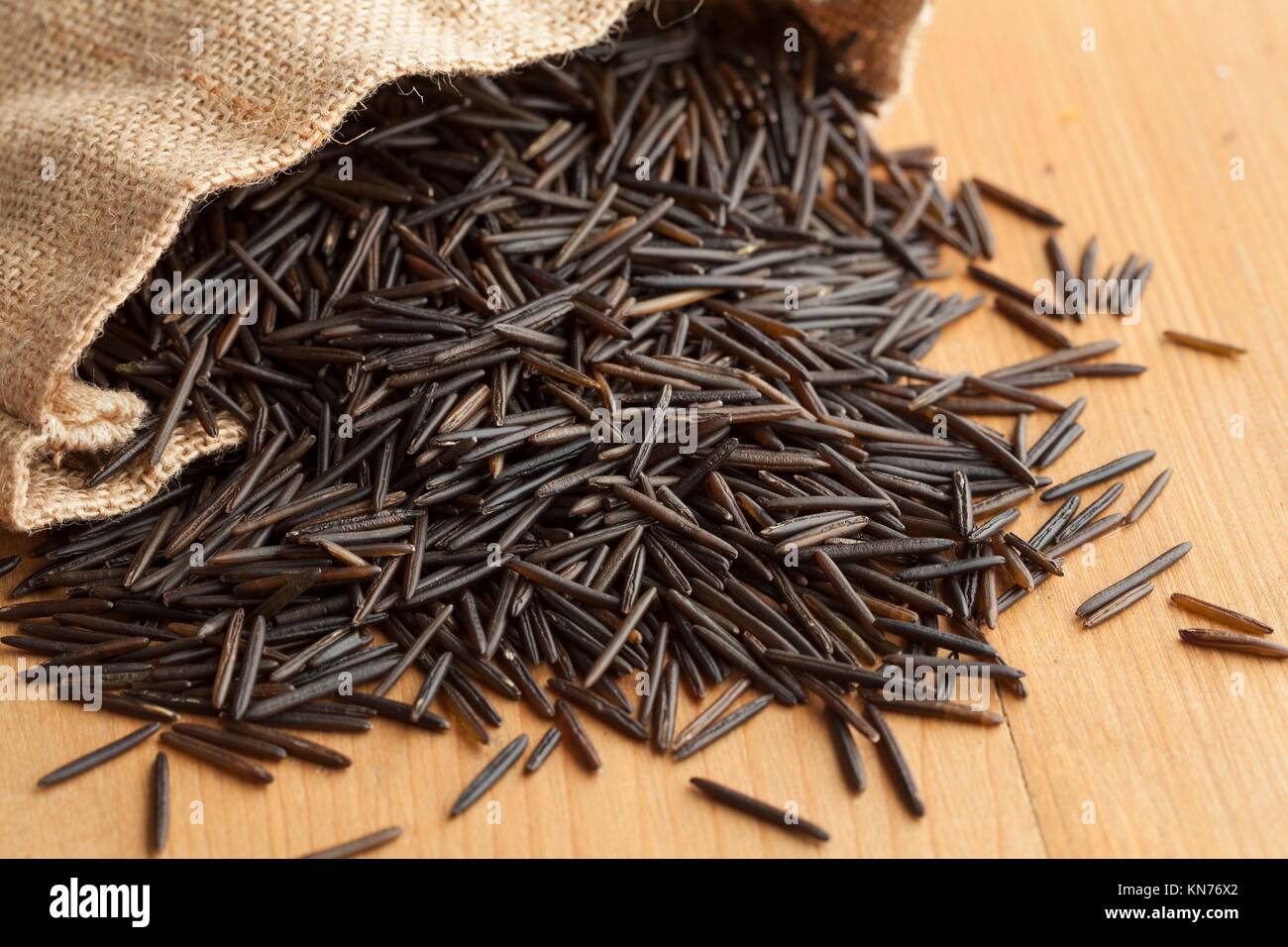 Raw black wild rice from a jute bag Stock Photo - Alamy