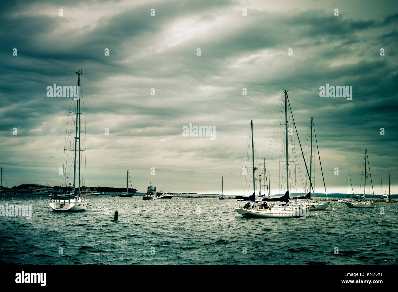 Nautical scene of anchored sailboats under storm clouds Stock Photo - Alamy
