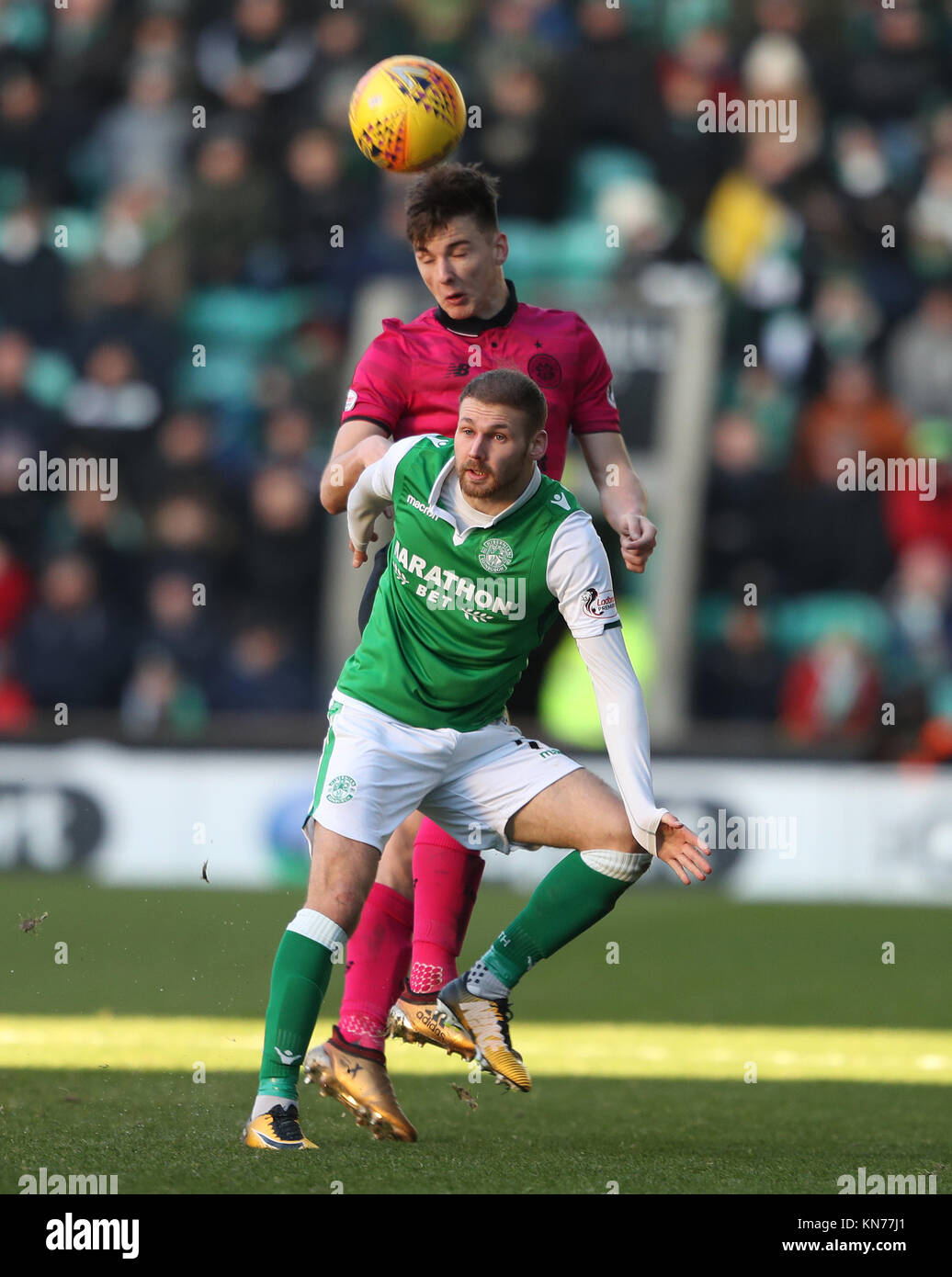 Celtic's Kieran Tierney (top) challenges Hibernian's Martin Boyle ...