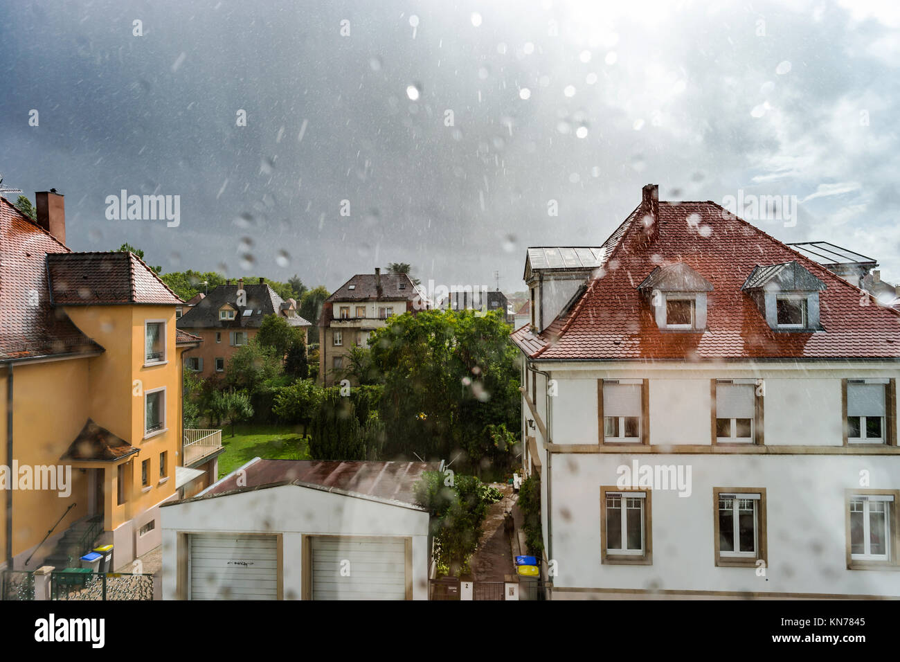 Rainy weather view through the window with water drops on the glass ...