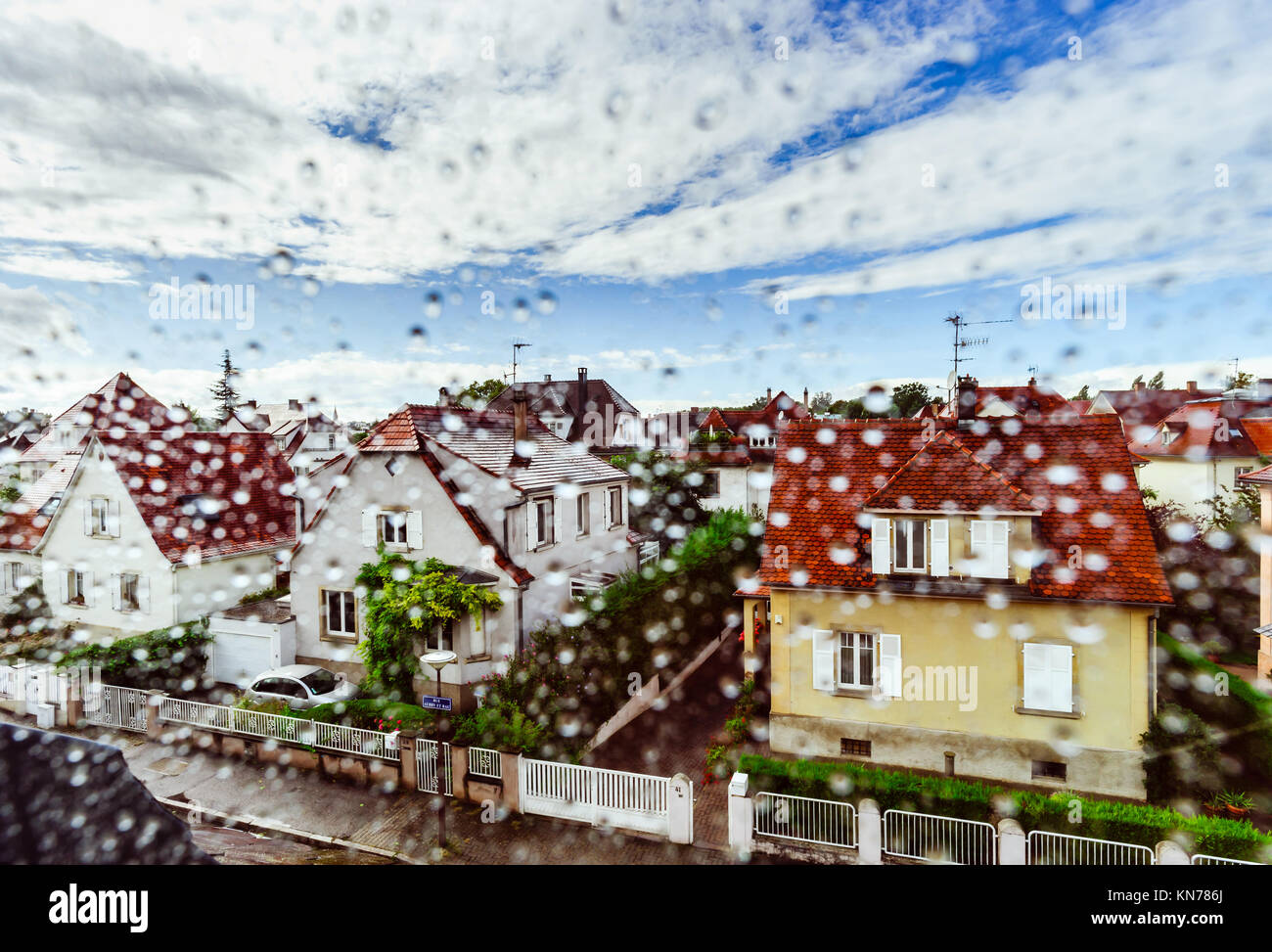 Rainy weather view through the window with water drops on the glass ...