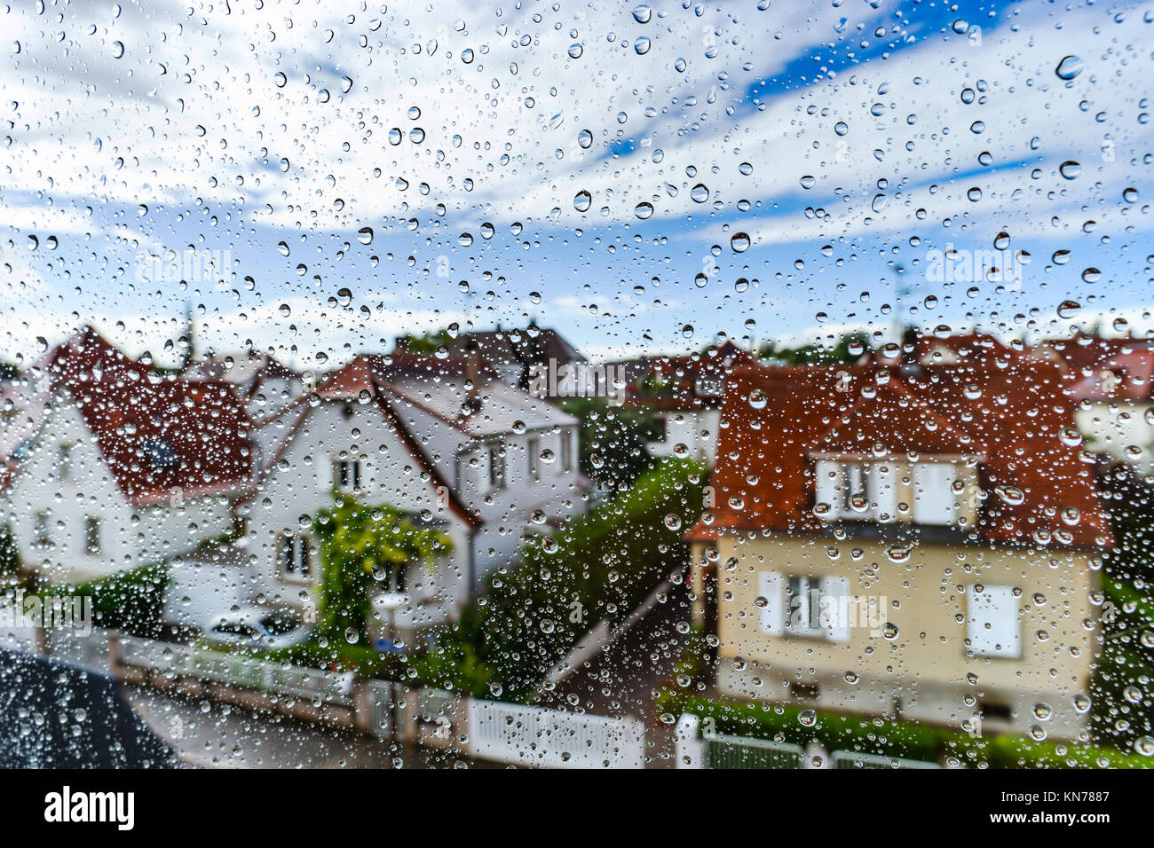 Rainy weather view through the window with water drops on the glass ...
