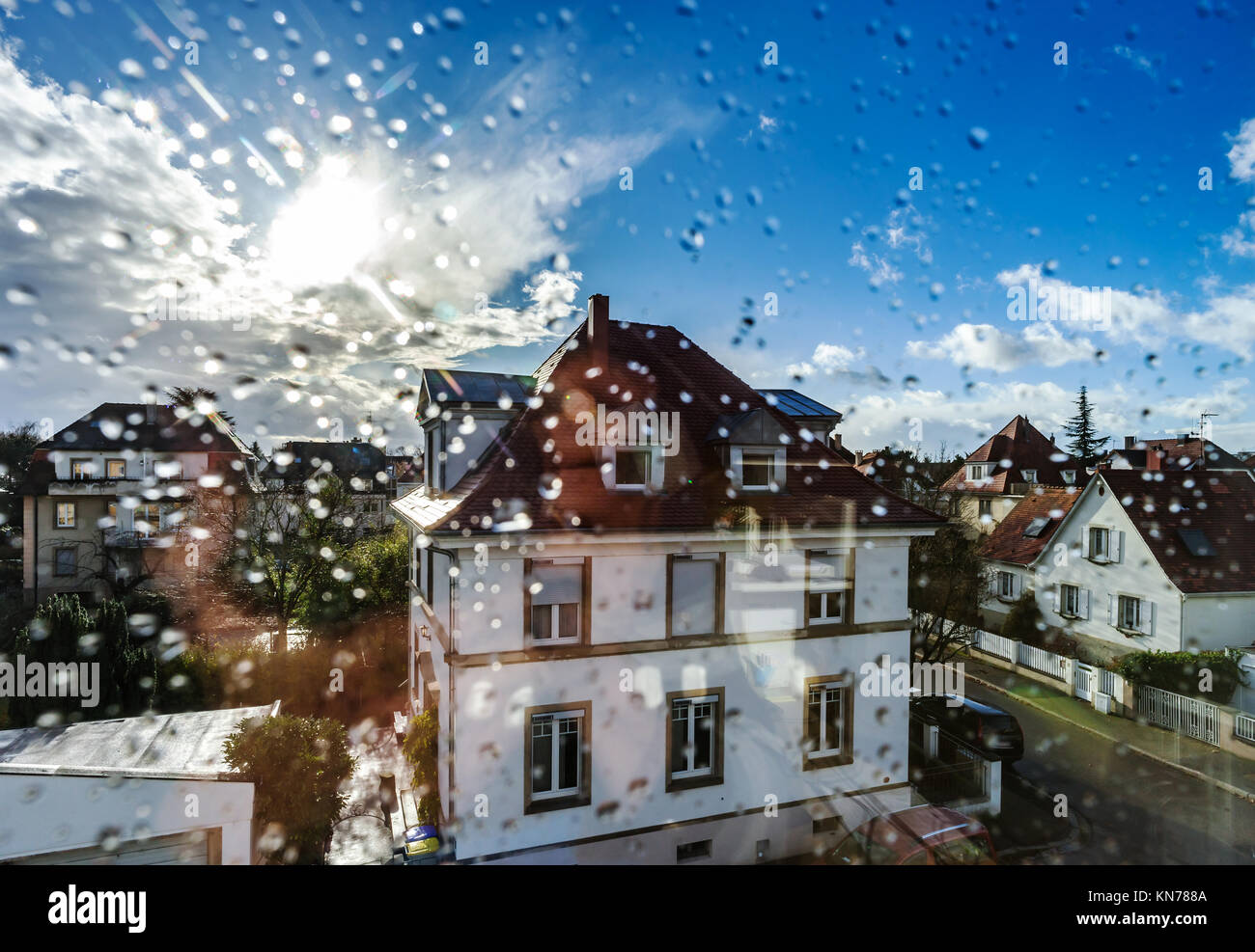 Rainy weather view through the window with water drops on the glass ...
