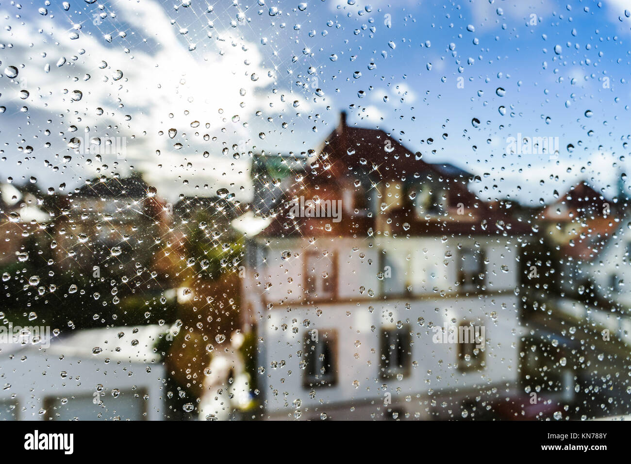 Rainy weather view through the window with water drops on the glass ...