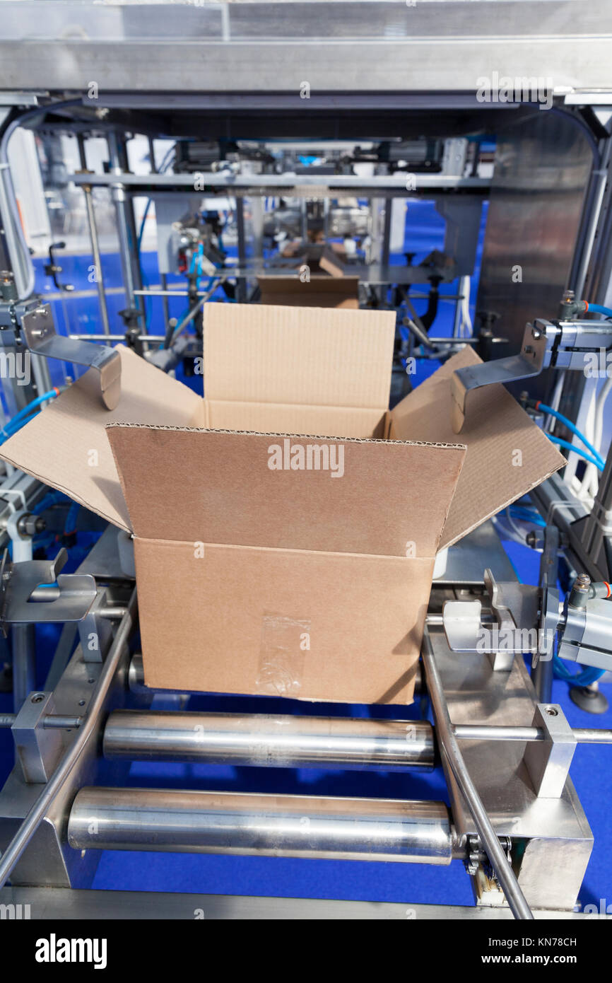 Automatic cardboard box erector machine Stock Photo - Alamy