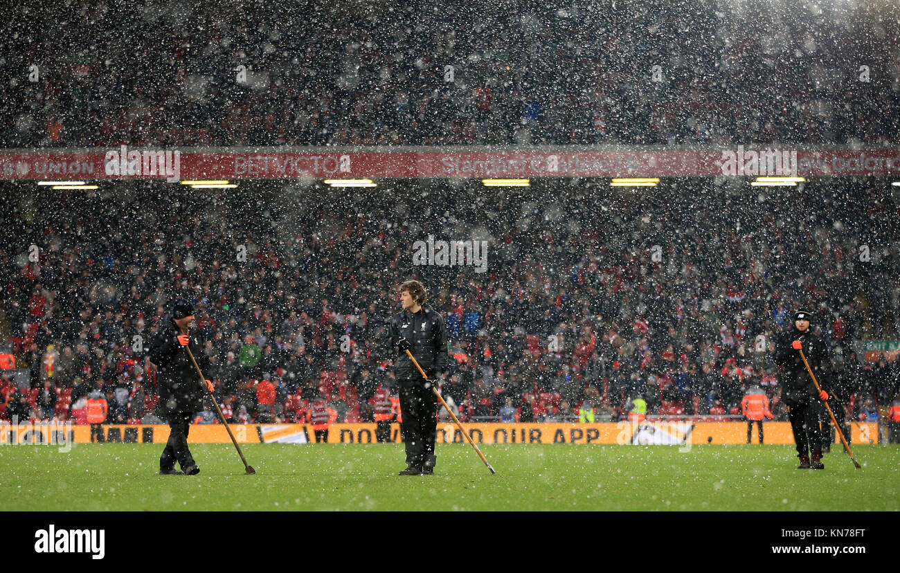 Ground staff tend to the pitch in the snow at half time during the ...