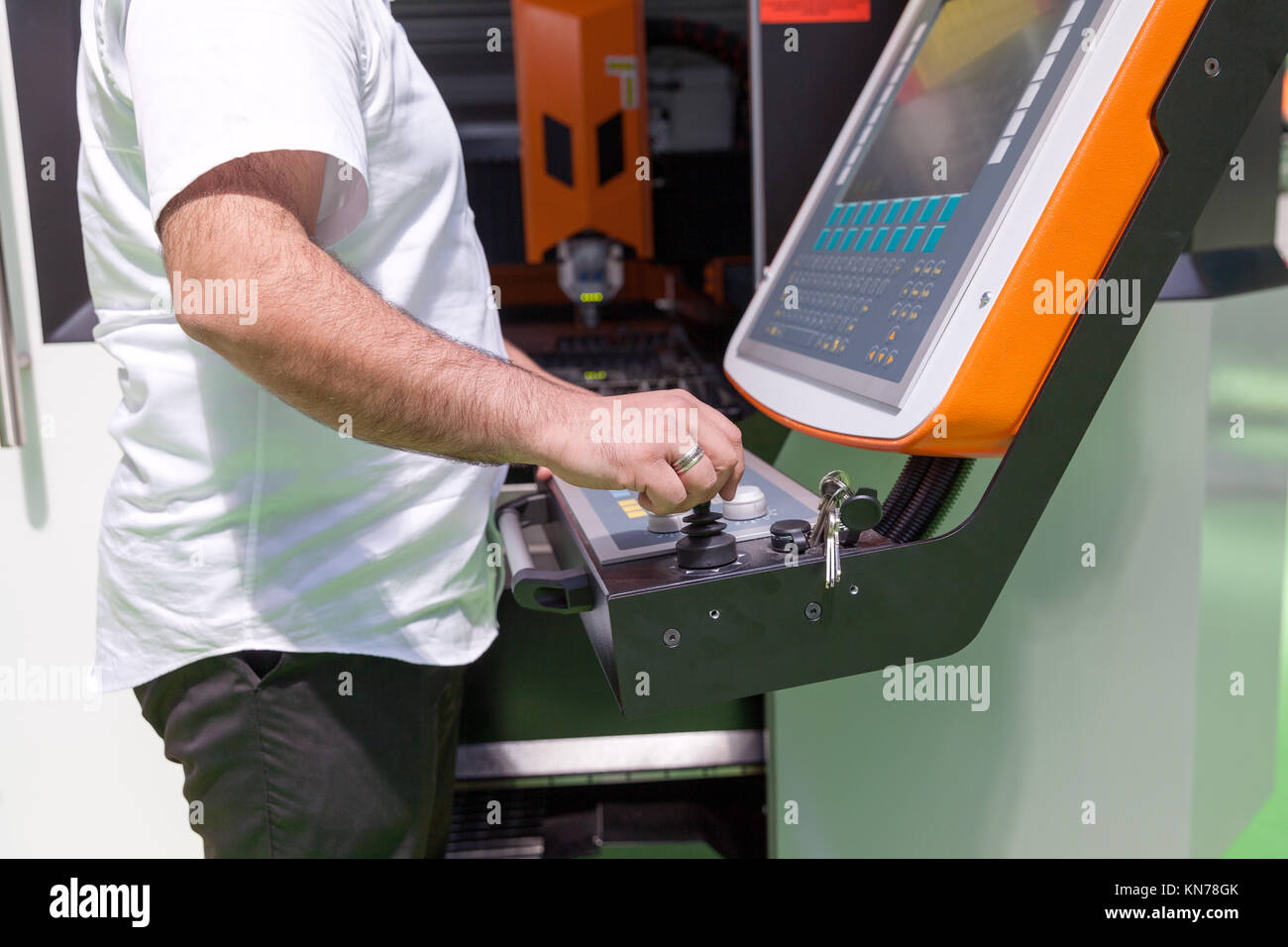 Man working at programmable CNC machine Stock Photo - Alamy