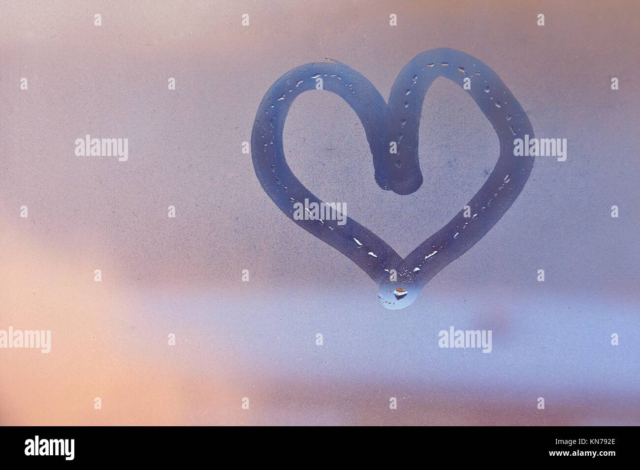 Heart painted with finger on foggy window Stock Photo - Alamy
