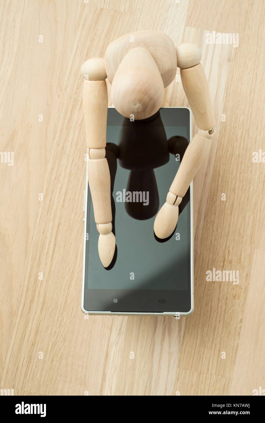 Wood doll with mobile phone. Concept of messaging, communication and ...