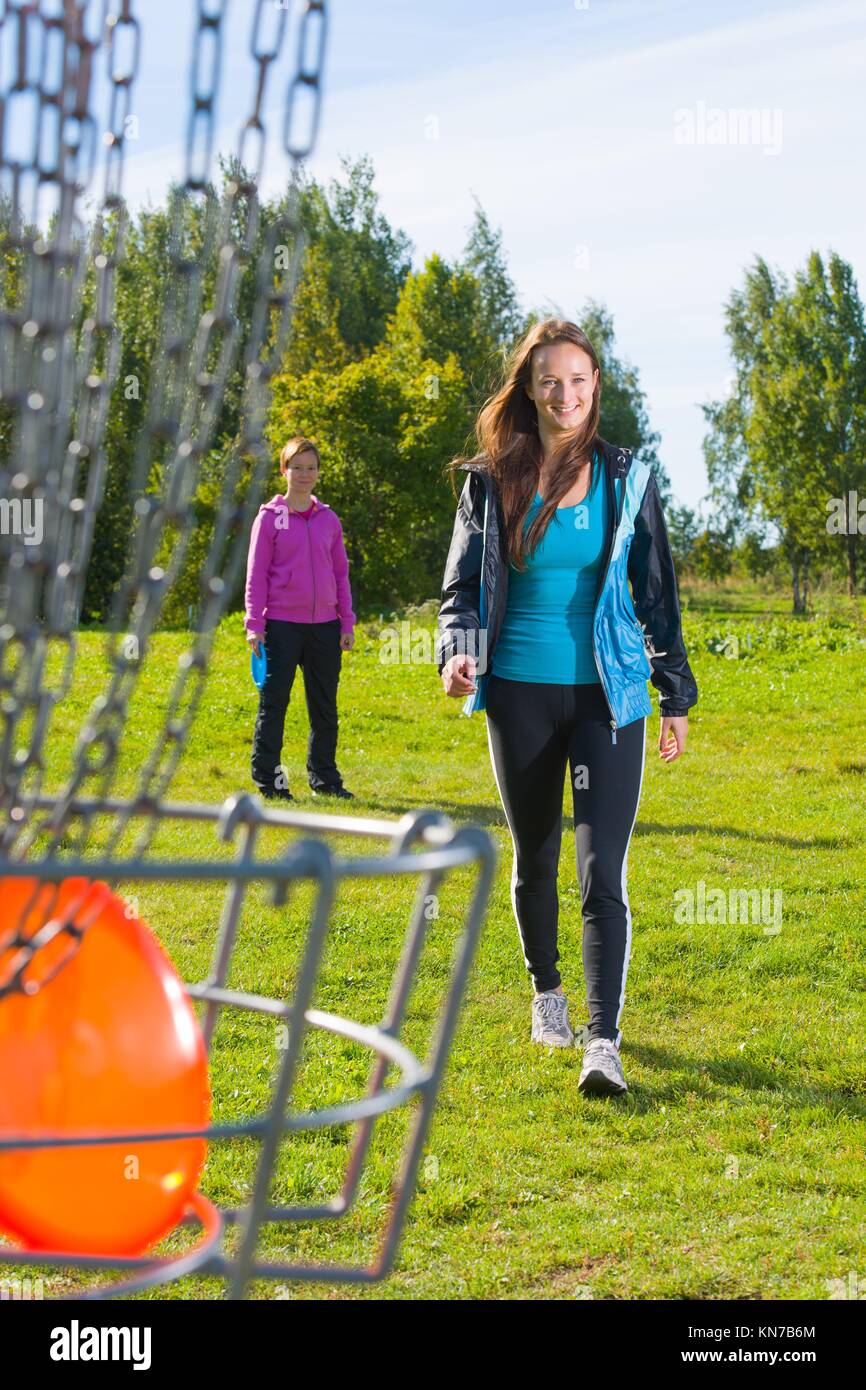 Disc inside of the basket, players on the background, focus on the ...