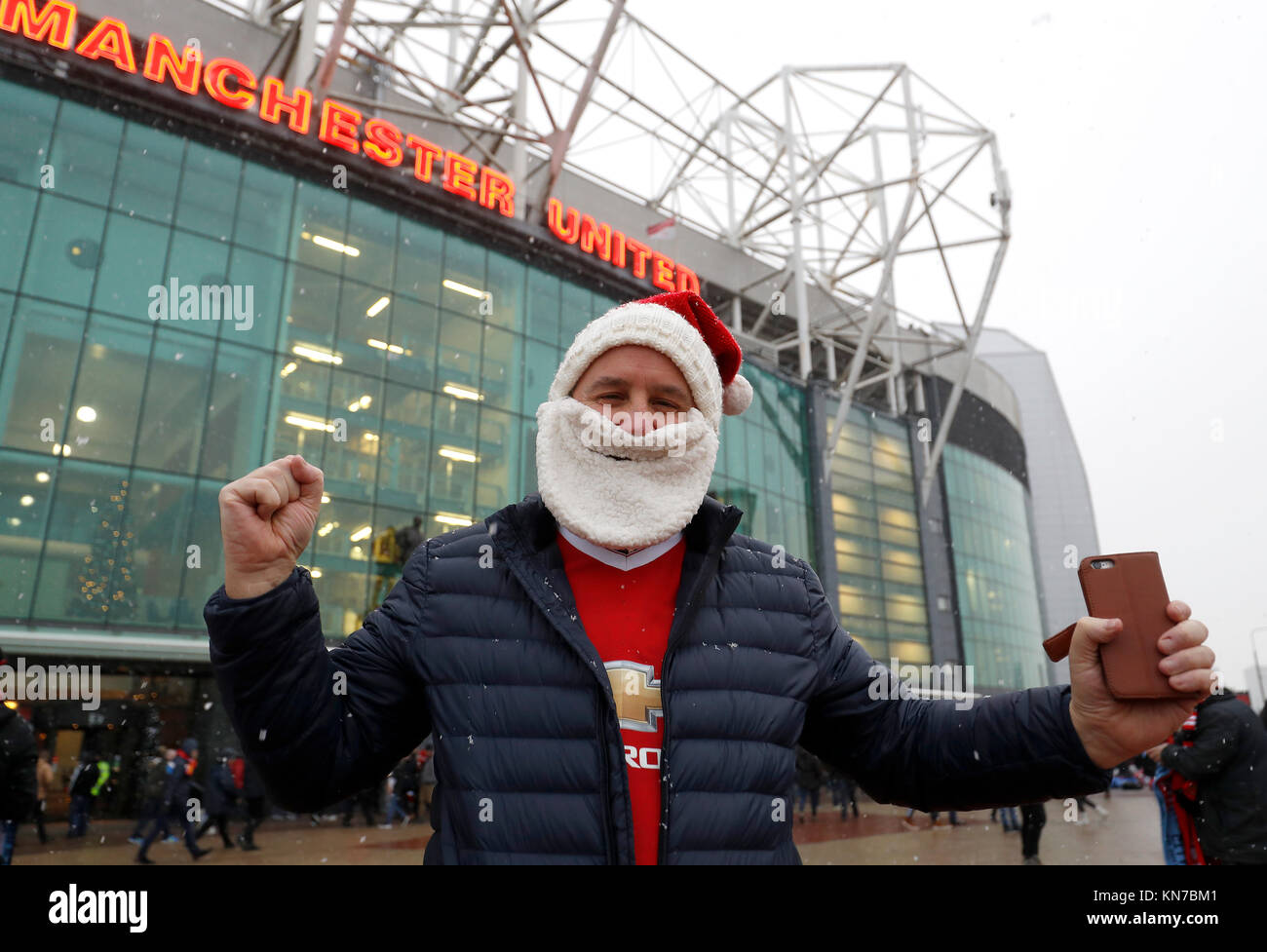 A fan poses for picture prior to the Premier League match at Old ...
